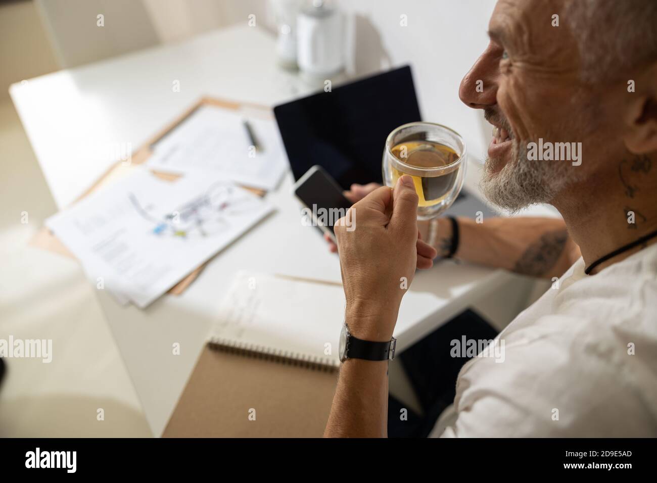 Man bringing a tea cup to his mouth Stock Photo - Alamy