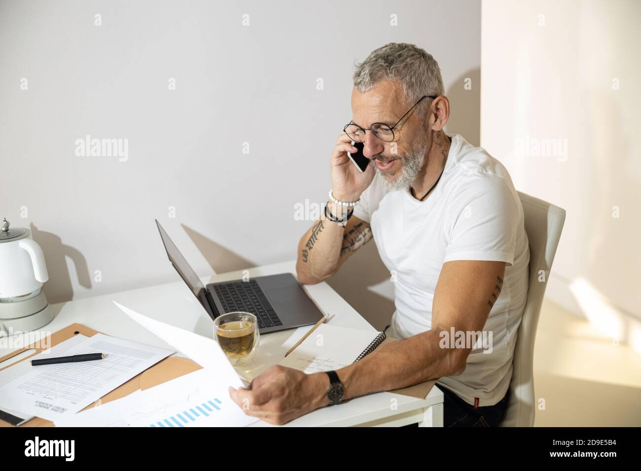 Busy man making a phone call about an official paper Stock Photo - Alamy