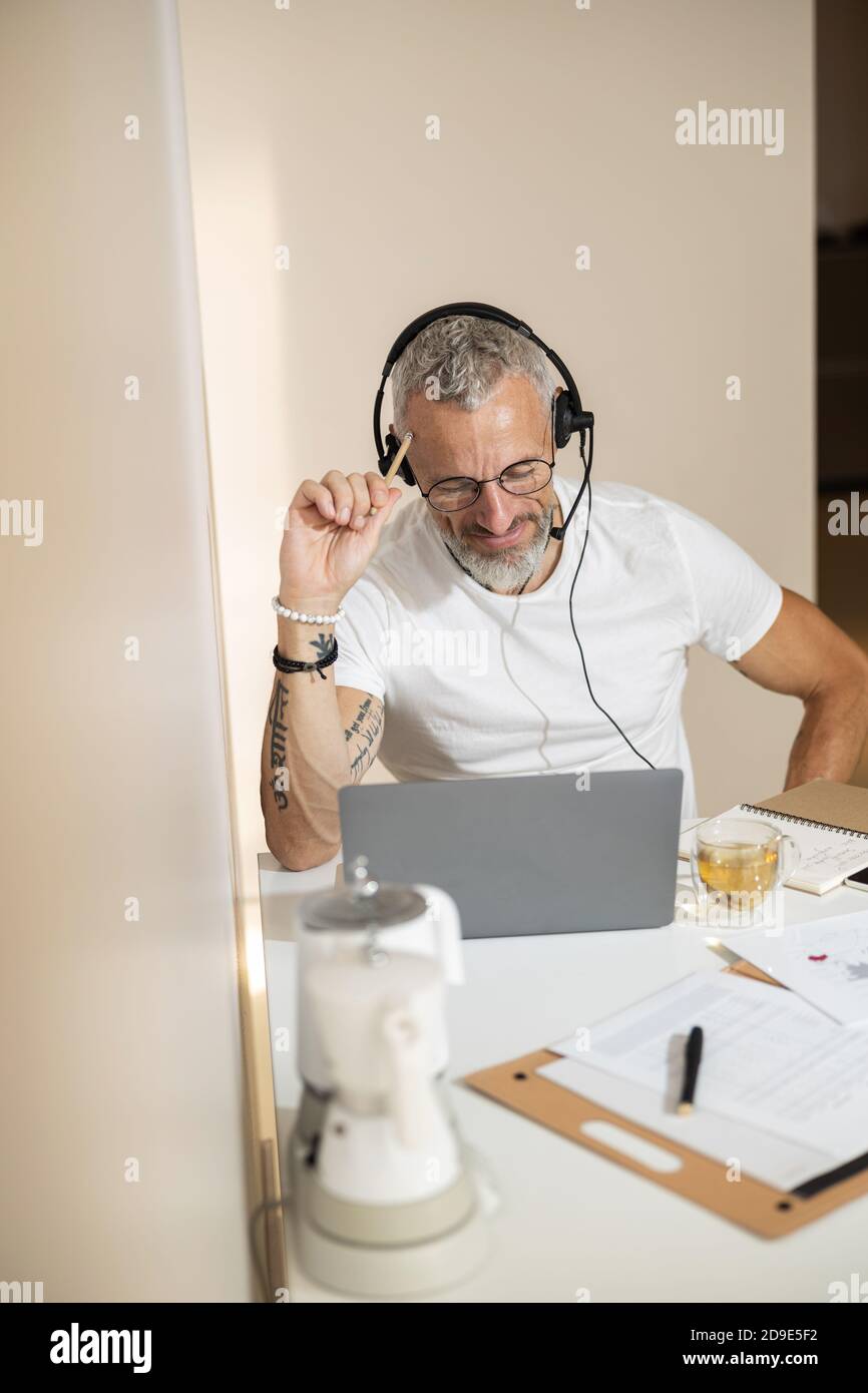 Serious conference participant looking at his laptop screen Stock Photo ...
