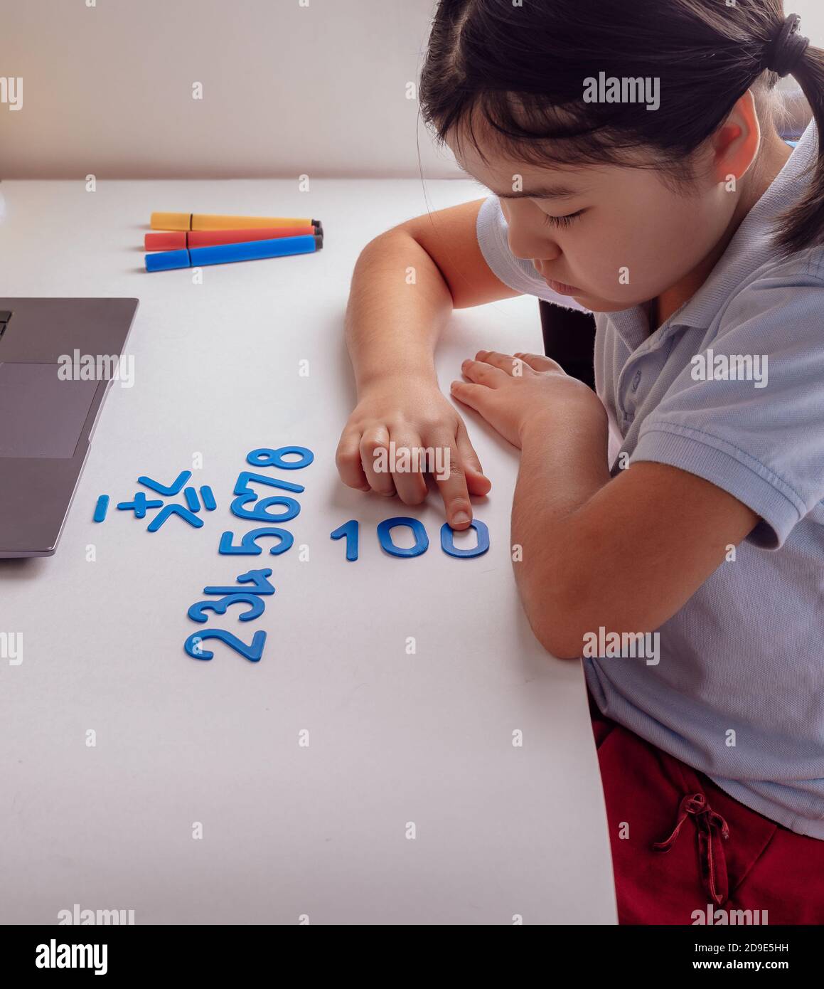 Asian schoolgirl studying homework math during her online lesson at ...