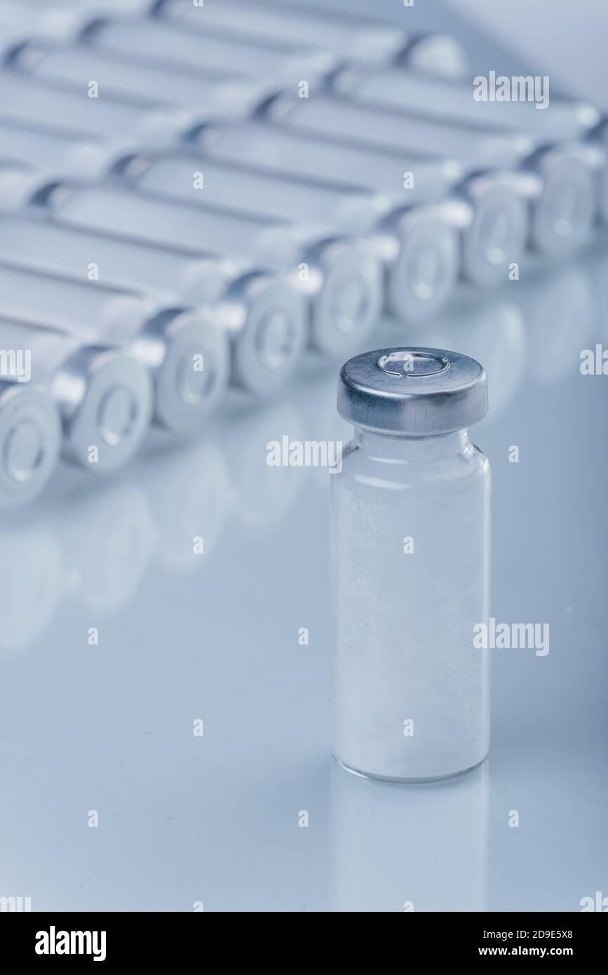 Glass medical ampoule vial for injection. Medicine is dry white drug ...