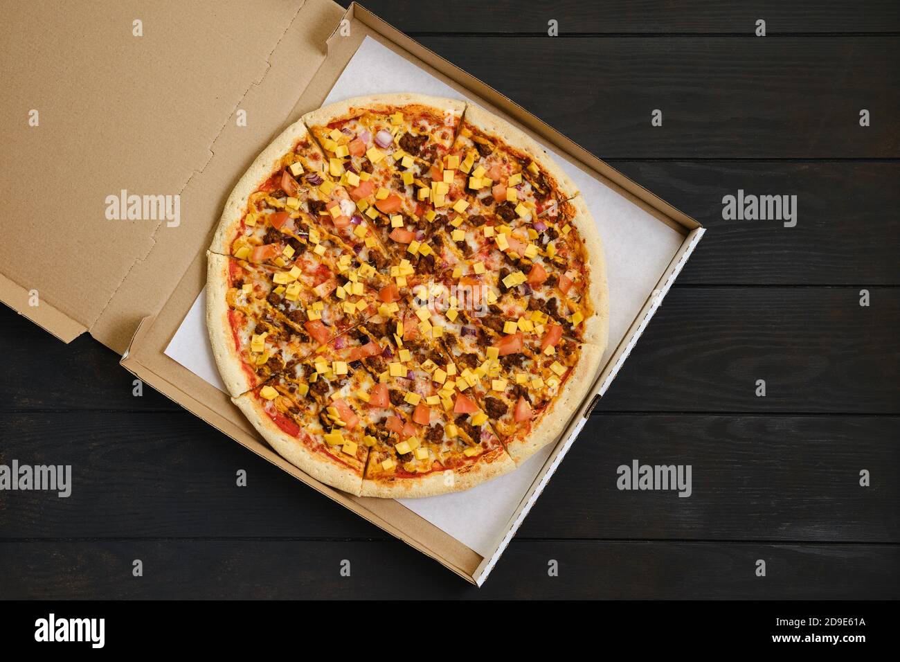 Top view of pizza with beef minced meat, tomato, onion and cheddar in ...