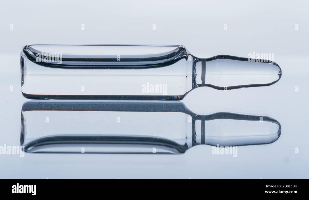 Glass medical ampoule vial for injection. Medicine is dry white drug ...