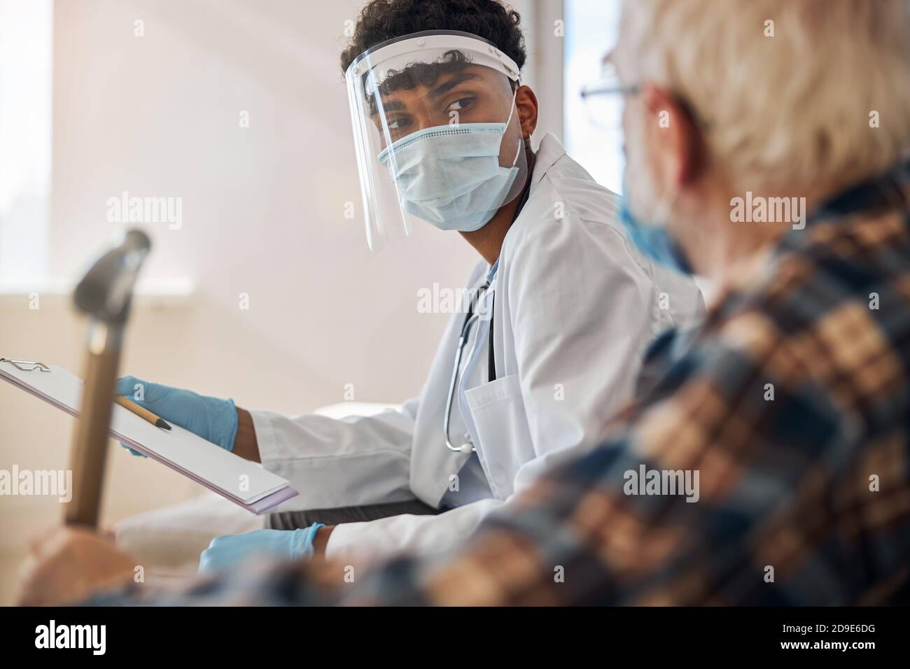 Doctor sitting next old hi-res stock photography and images - Alamy