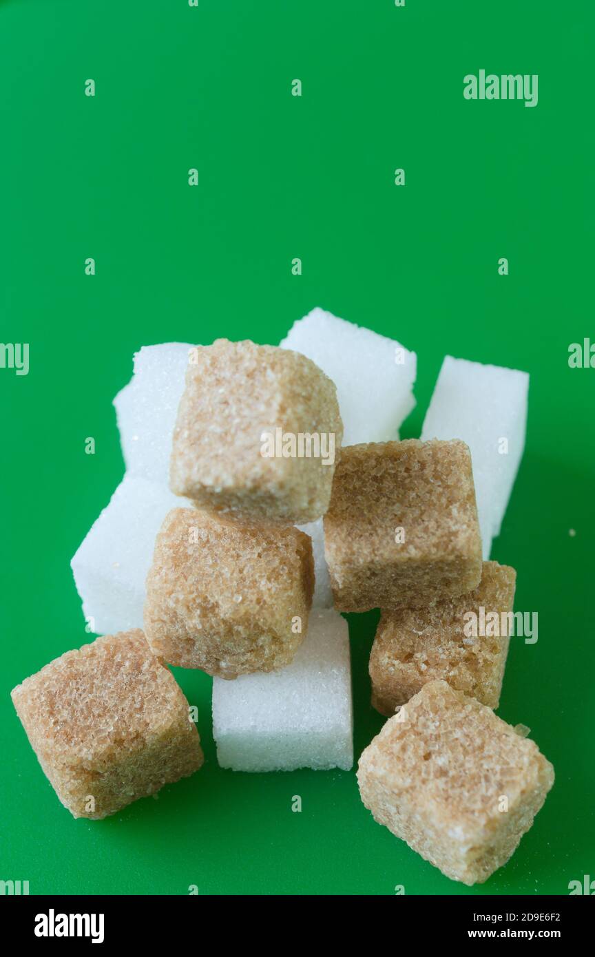 Cube of white and brown sugar on a green background. Green screen ...