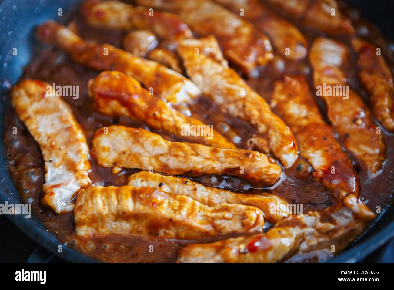 Braised beef meat strips cooking in caramel sauce for dinner in ...