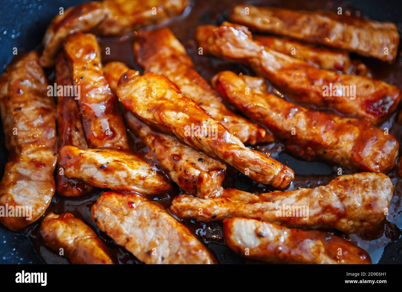 Braised beef meat strips cooking in caramel sauce for dinner in ...