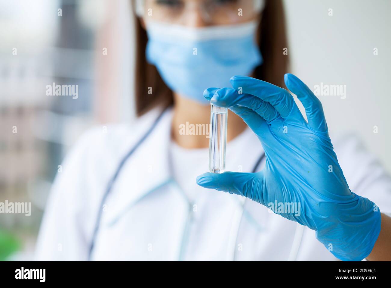 Woman doctor holding test tube with covid-19 coronavirus vaccine Stock ...