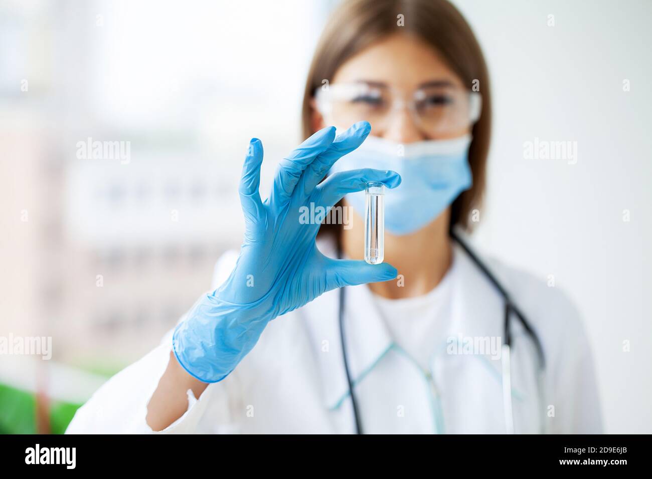 Woman doctor holding test tube with covid-19 coronavirus vaccine Stock ...