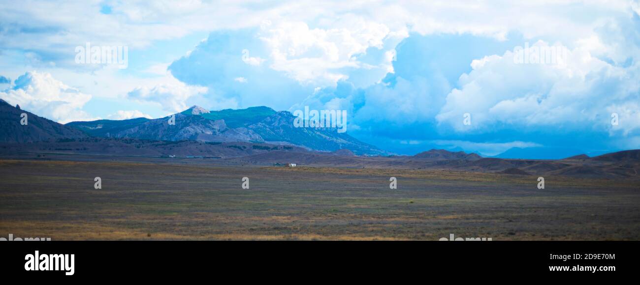 Landscape panorama. Mountains plain sky with clouds. Picturesque area ...