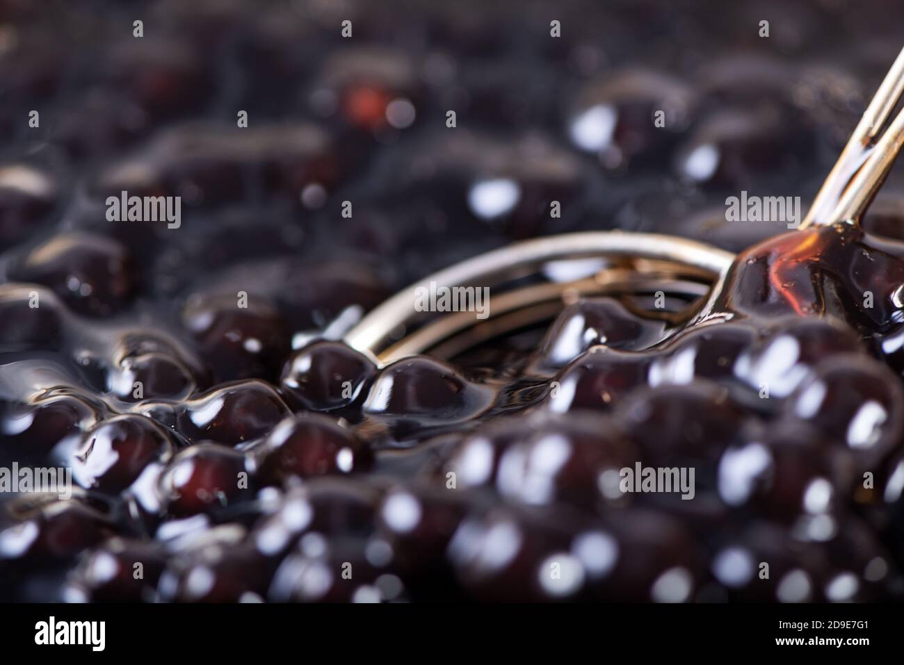 Cooking, boiling brown sugar flavored tapioca pearl balls, ingredient ...