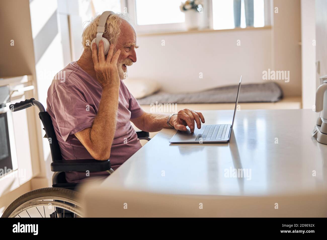 Disabled man working on his portable computer Stock Photo - Alamy
