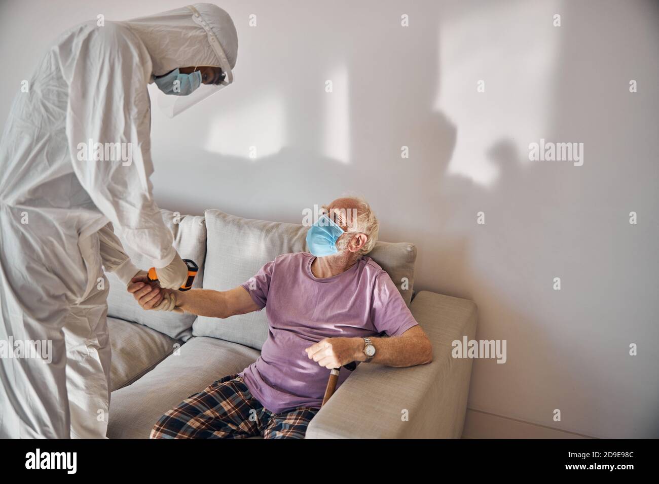 Healthcare professional using an infrared thermometer on the patient ...