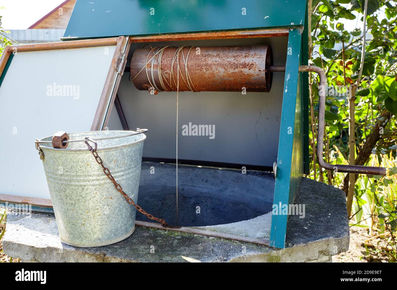 Old draw-well in European village. Retro stone water well in rural area ...