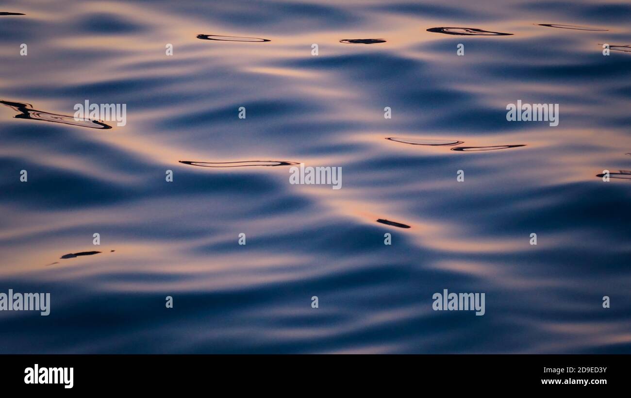 Calm water waves texture background wallpaper, pink reflection Stock ...