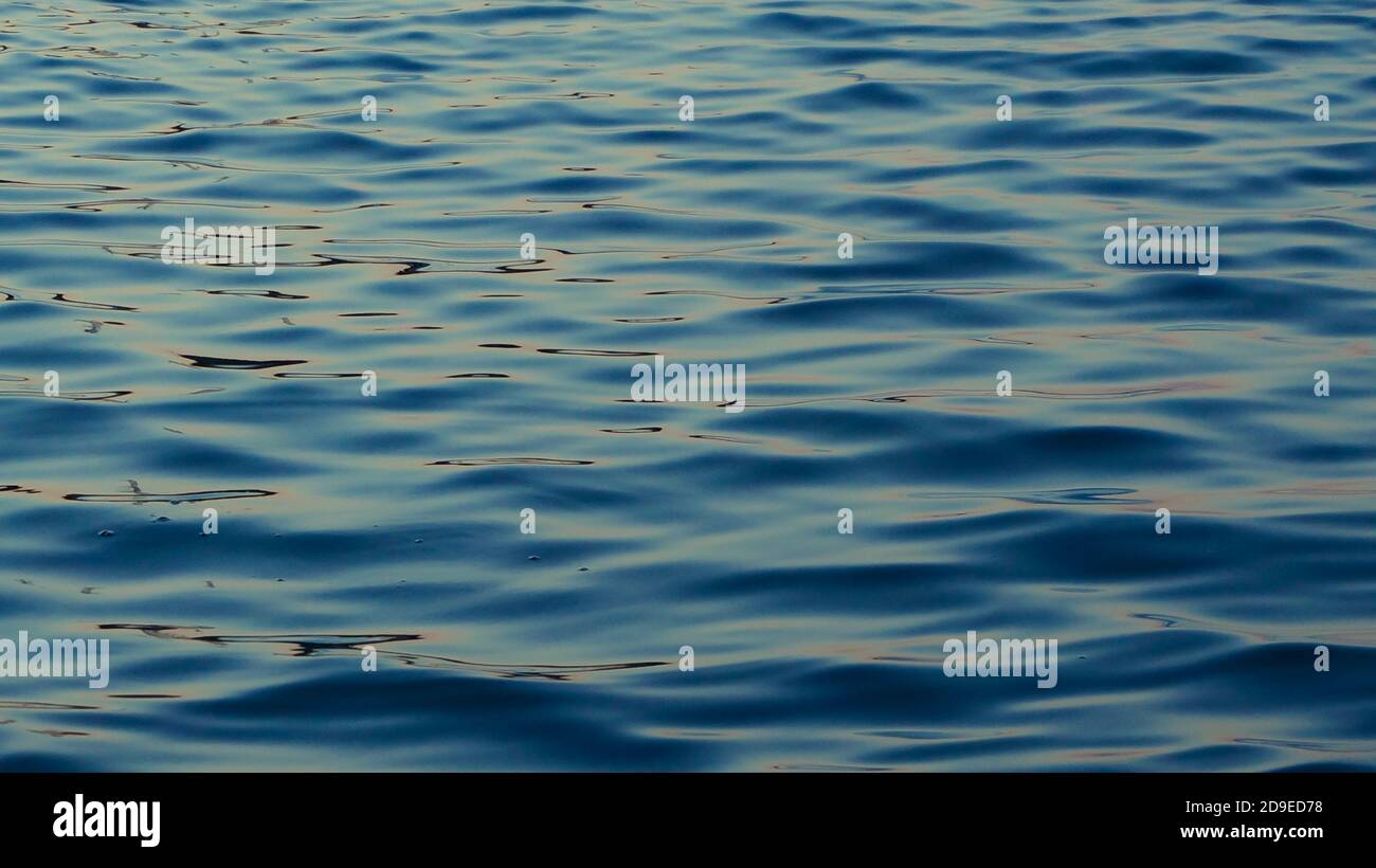 Calm water waves texture background wallpaper, pink reflection Stock ...