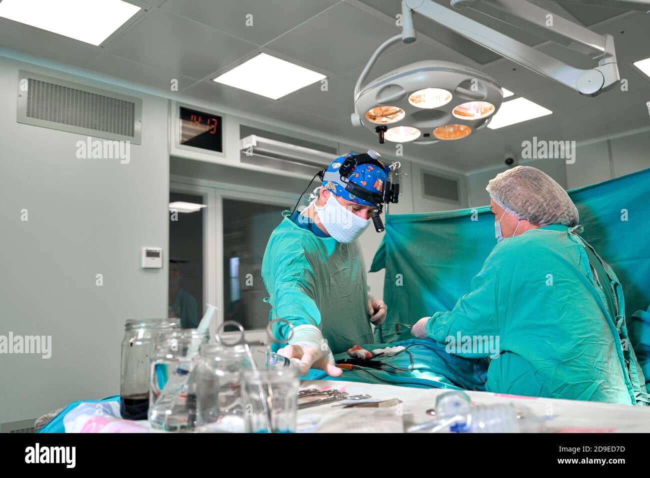 Surgeon and his assistant performing cosmetic surgery on nose in ...