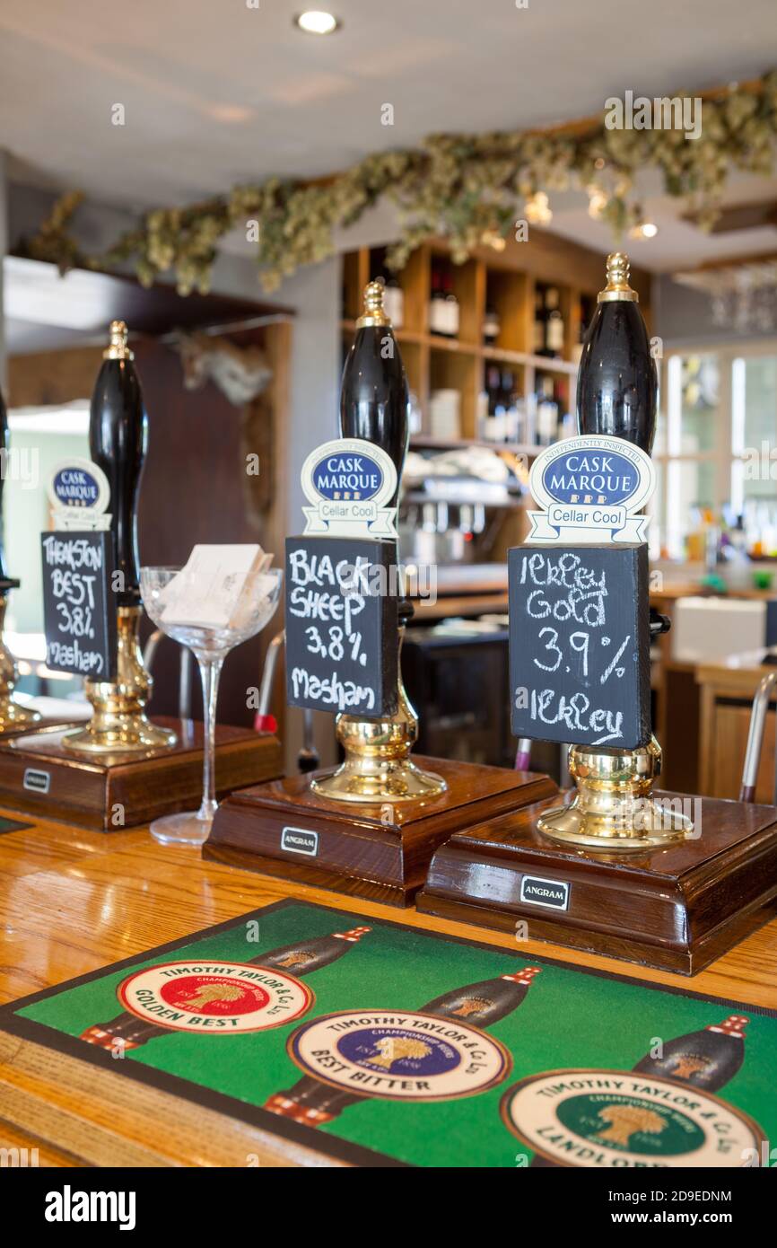 Traditional hand pumps for real ale on the bar of an English pub Stock ...