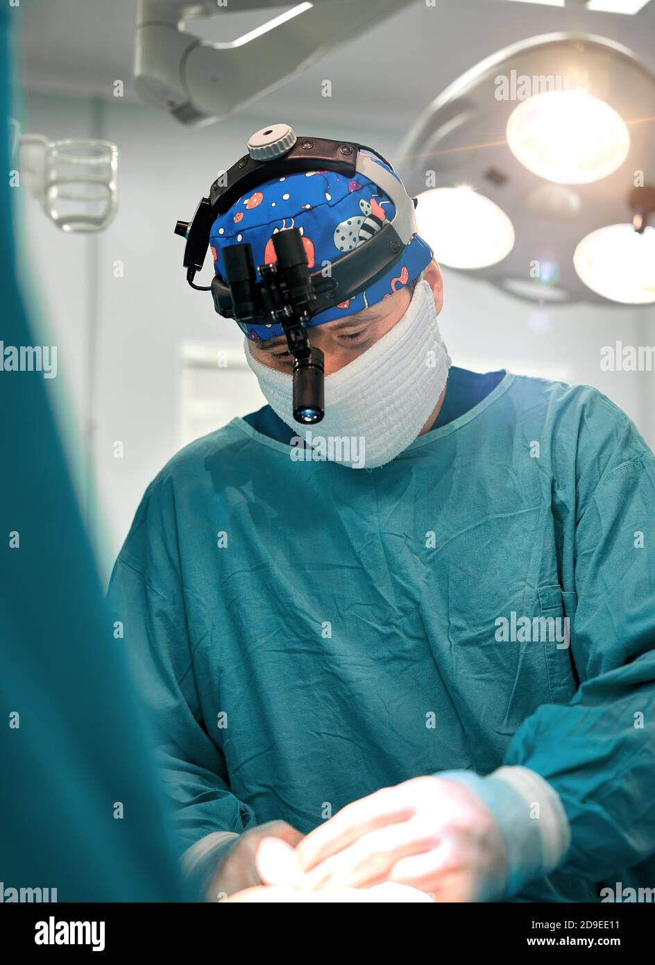 Surgeon and his assistant performing cosmetic surgery on nose in ...