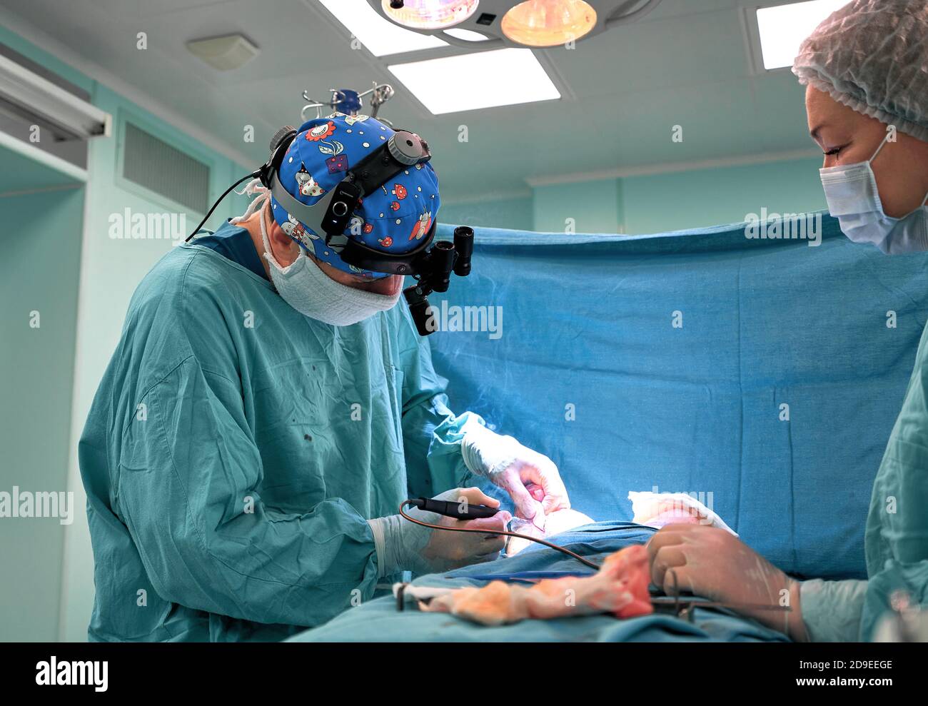 Surgeon and his assistant performing cosmetic surgery on nose in ...