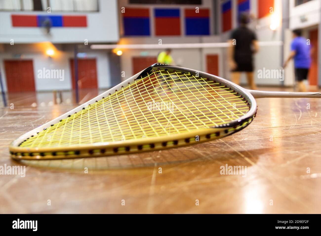 Broken badminton racquet rim with court as background Stock Photo - Alamy