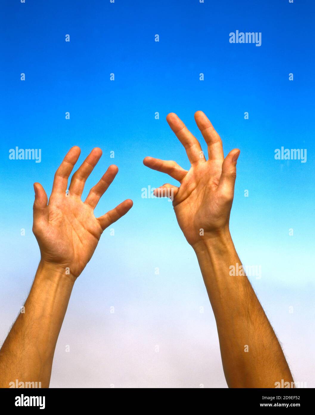 human hands on a blue and white background Stock Photo - Alamy
