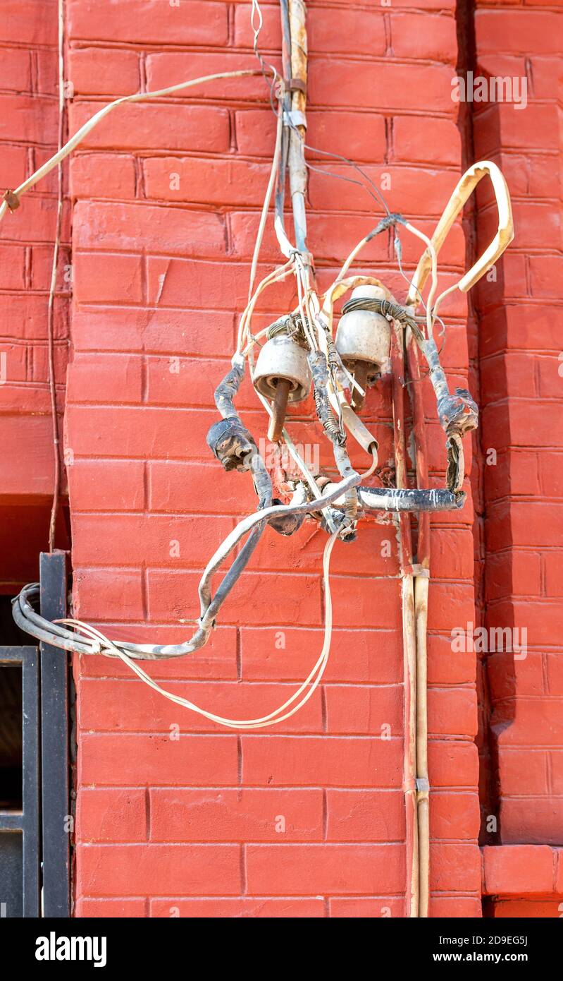 Electrical high voltage wiring lines on the wall of old building Stock ...