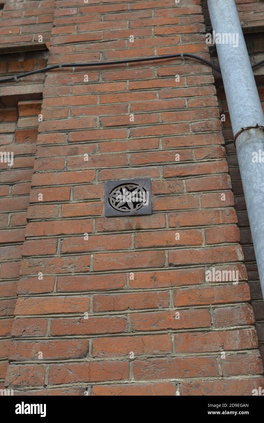 Ventilation grill on a brick wall. Gutter gray pipe Stock Photo - Alamy