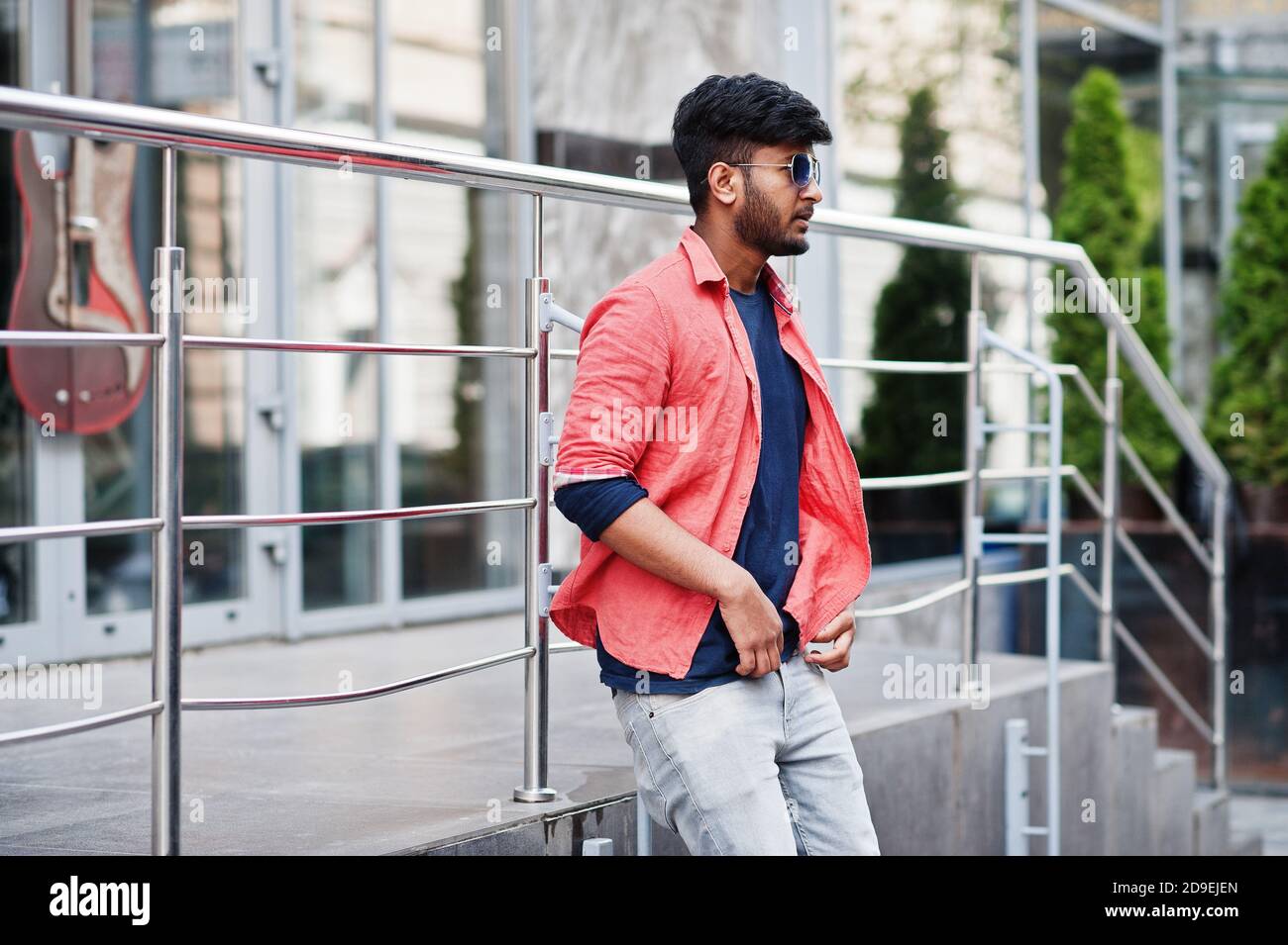 Portrait of young stylish indian man model pose in street in sunglasses ...