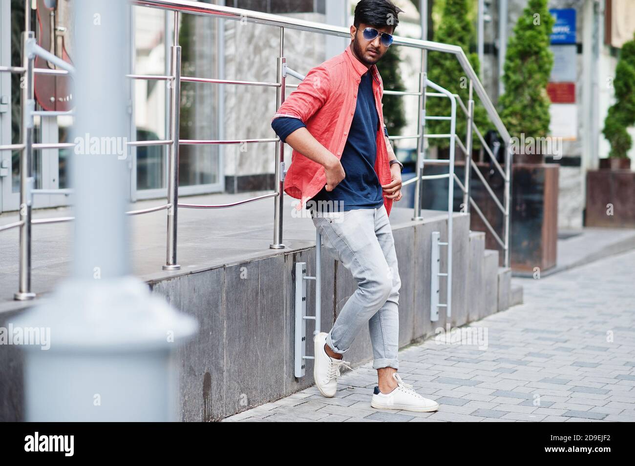 Portrait of young stylish indian man model pose in street in sunglasses ...