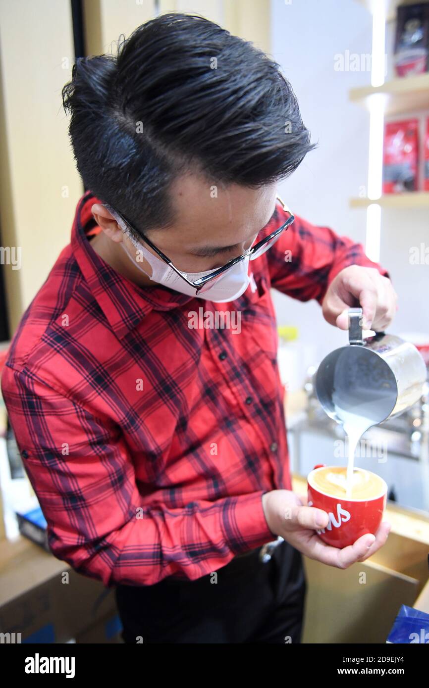 Shanghai. 5th Nov, 2020. A staff member makes coffee at the booth of ...