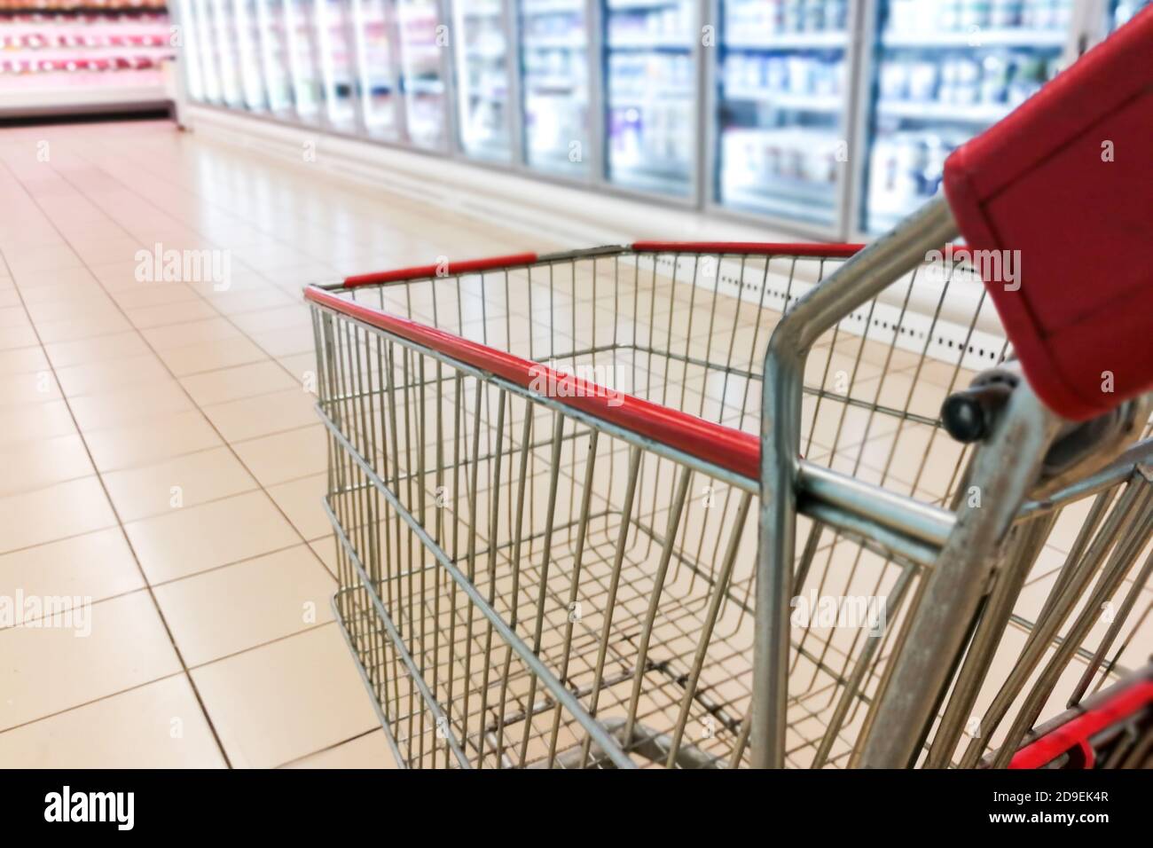 Shopping trolley cart at supermarket chiller frozen aisle Stock Photo ...