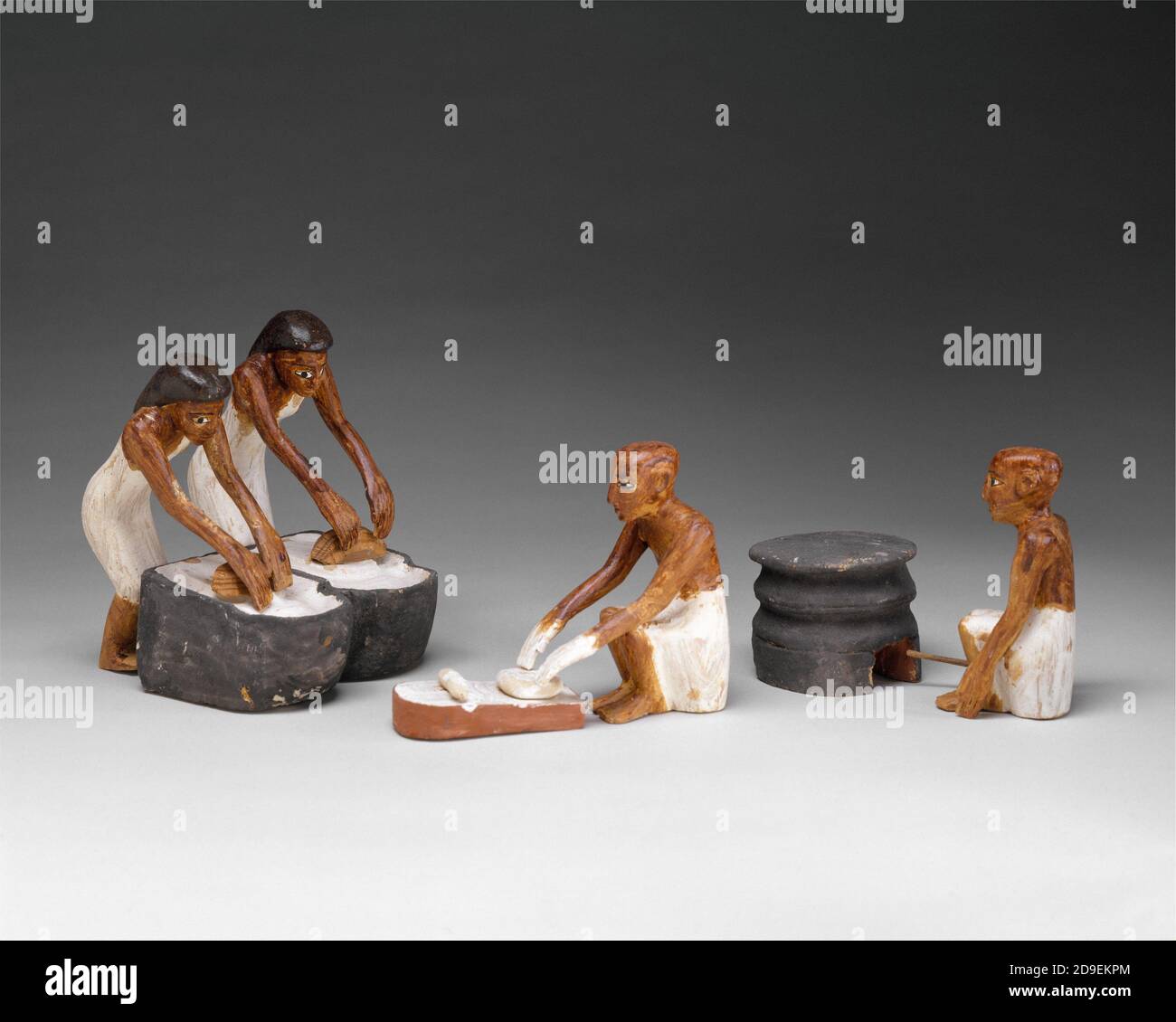 Models of men who make bread from THEMETMUSEUM NYC Stock Photo - Alamy