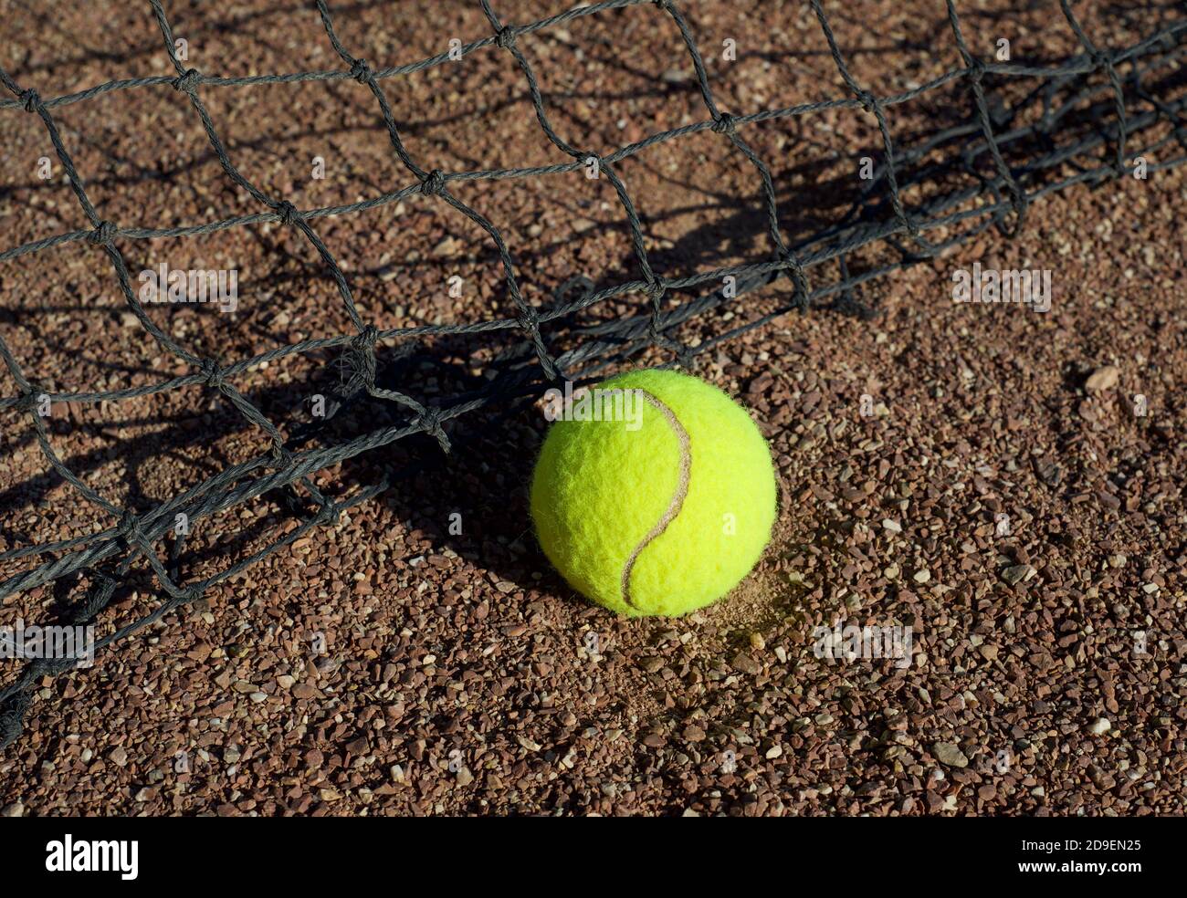Tennis ball on the ground against the background of a tennis net ...