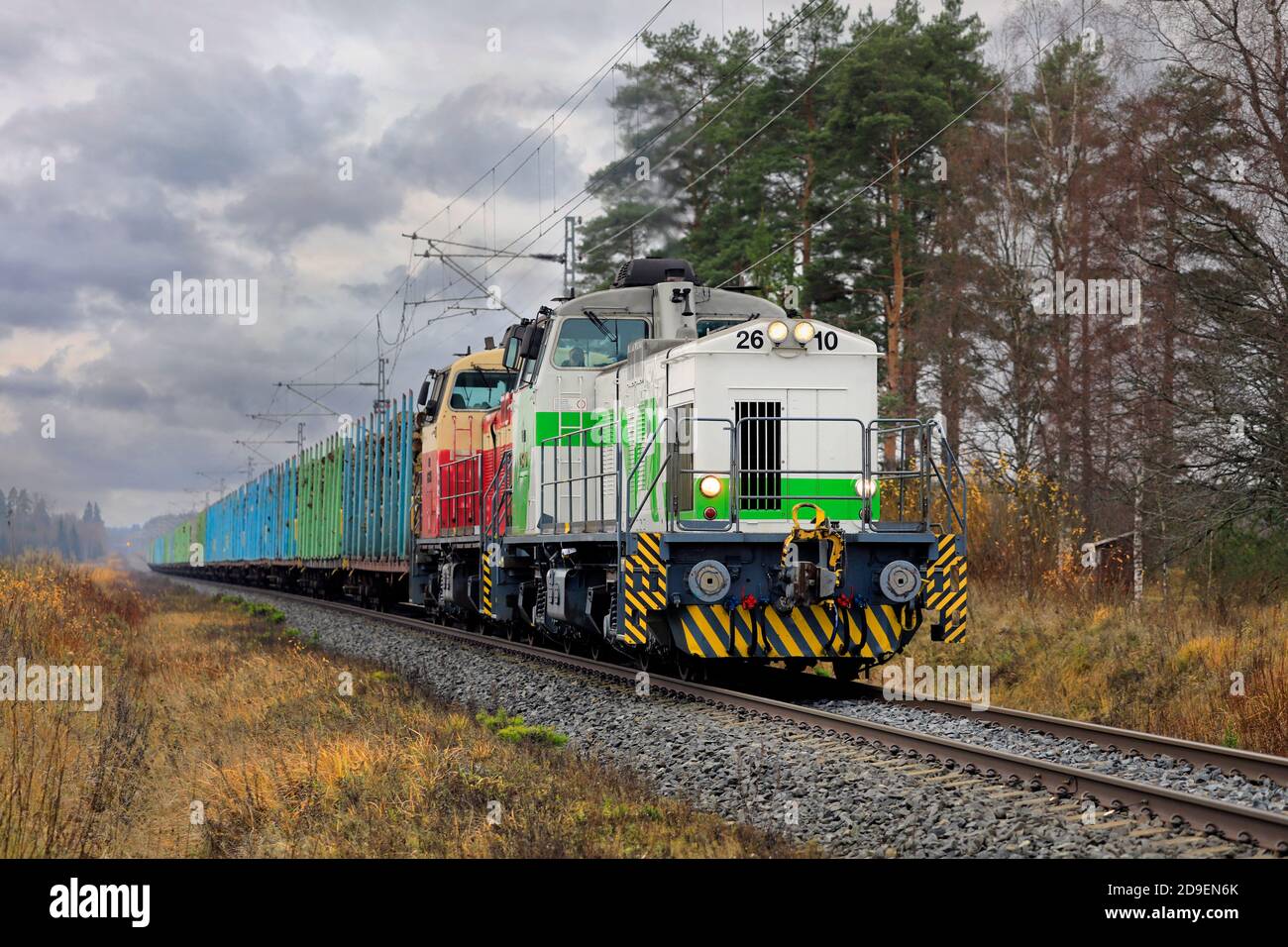 VR freight train with two diesel locomotives and carriages full of wood ...