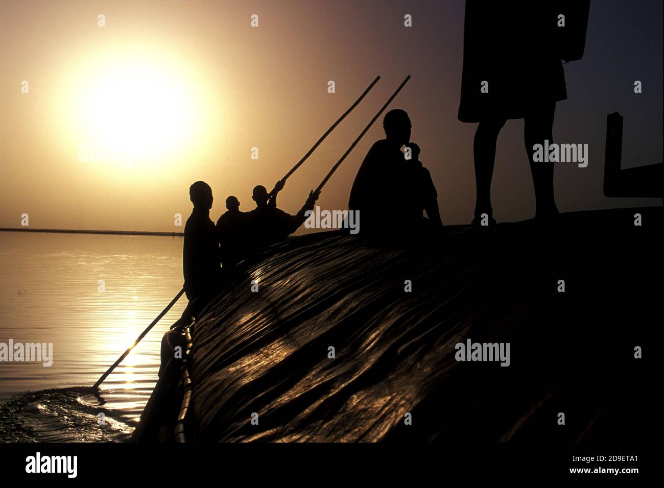 Boat crosses the Niger river in Mali during sunset near Timbuktu, Mali ...