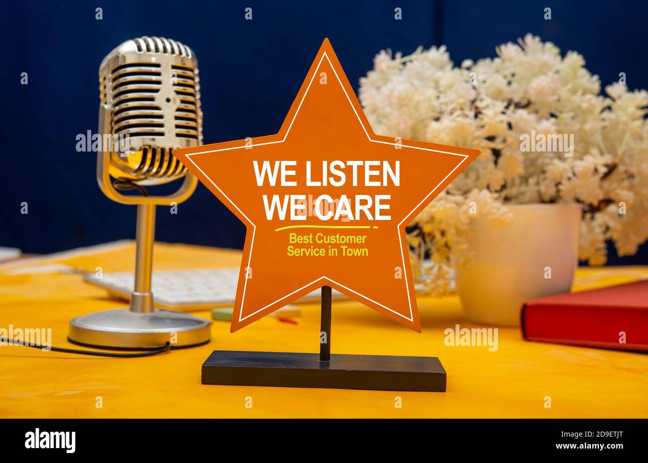 Customer care star sign in office with we listen sign Stock Photo - Alamy