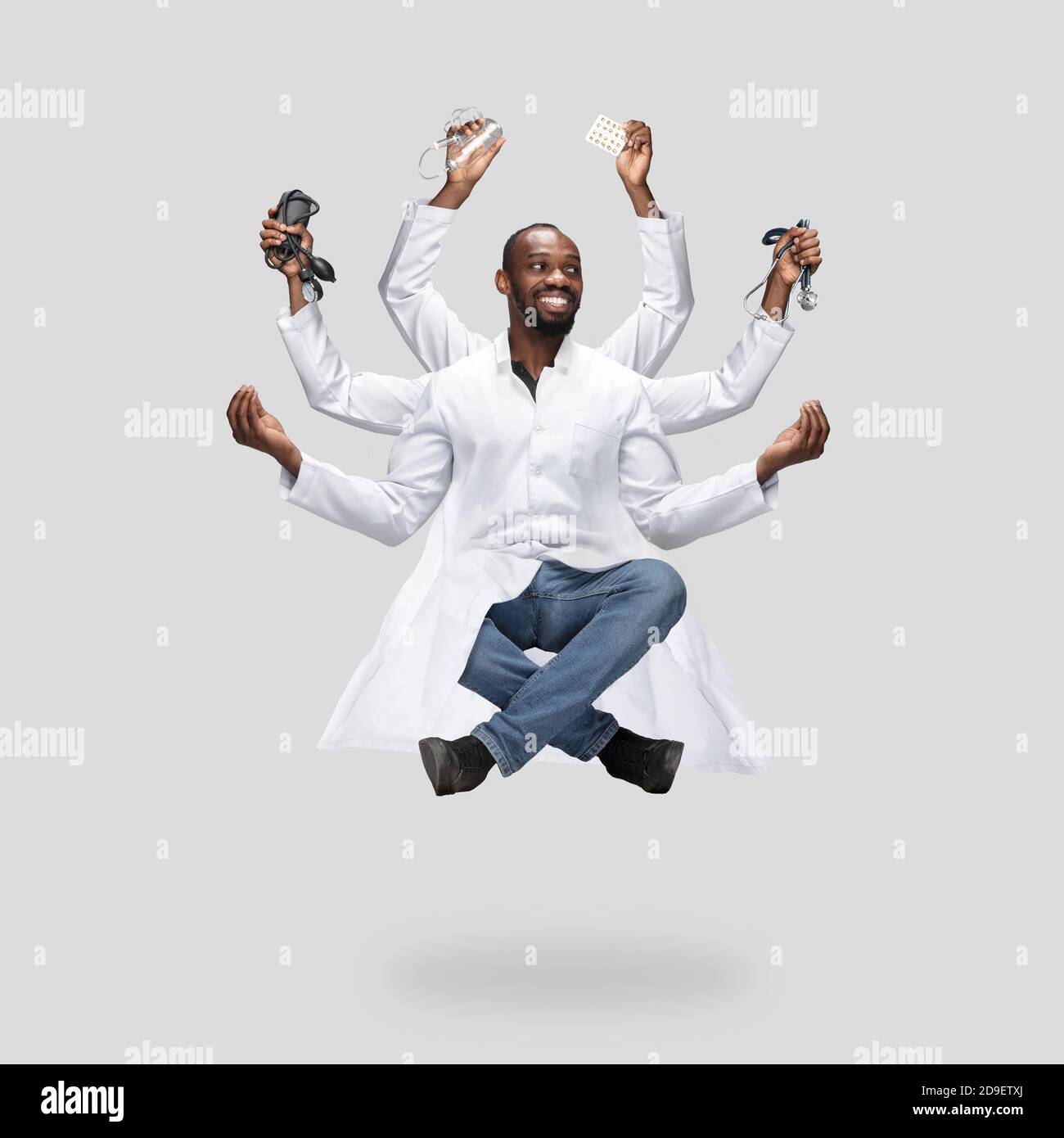 Handsome african doctor, multi-armed man levitating isolated on grey ...