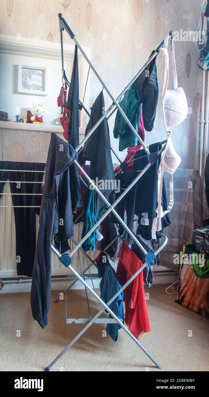Drying recently washed clothes indoors on a drying rack Stock Photo - Alamy