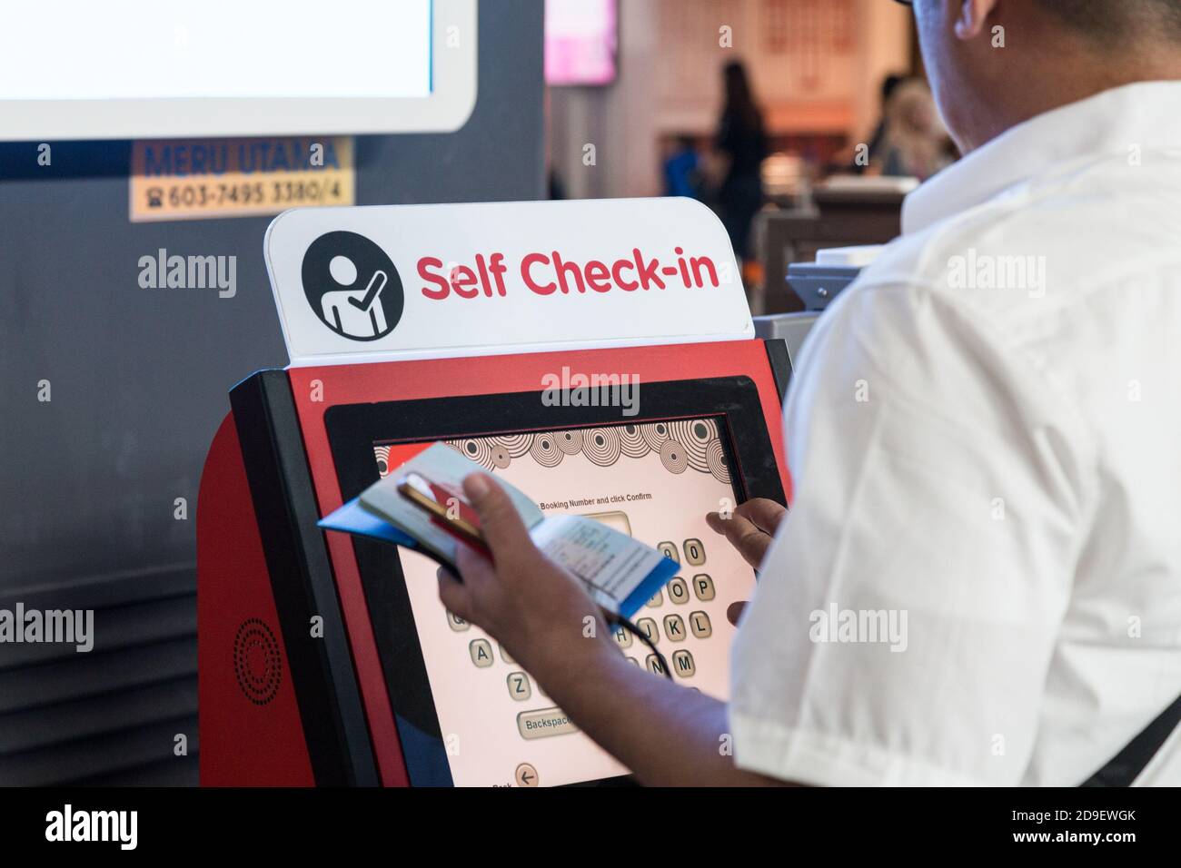 Passenger using convenient self check-in kiosk machine at KL ...