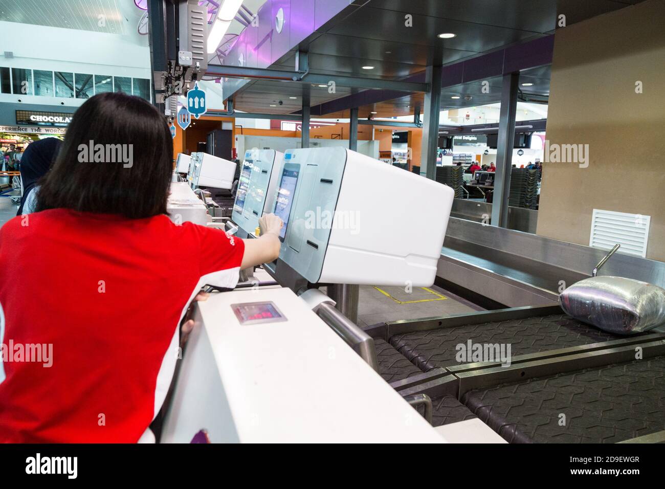 Passenger using convenient self check-in luggage bag machine at KL ...