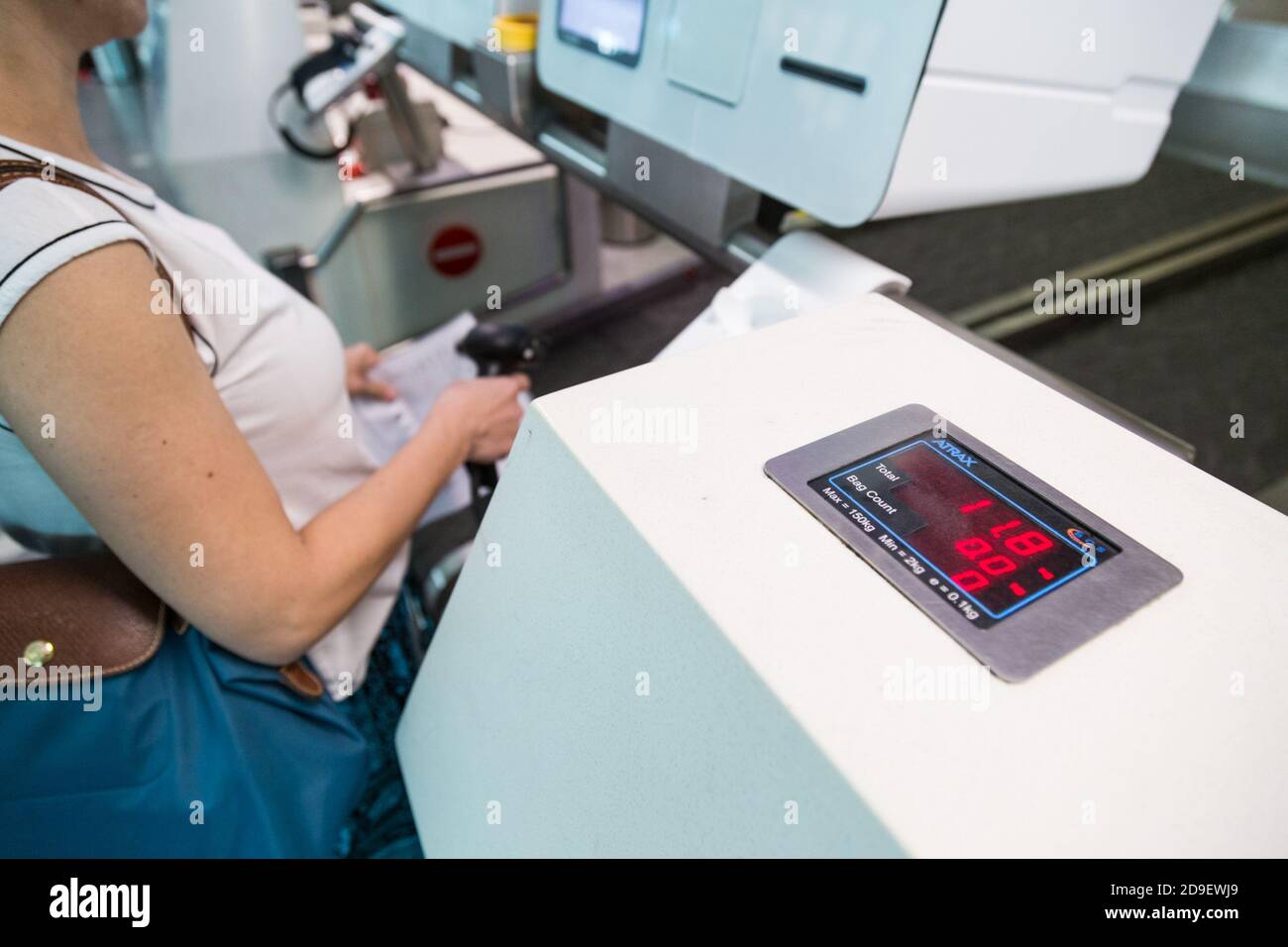 Passenger using convenient self check-in luggage bag machine at KL ...