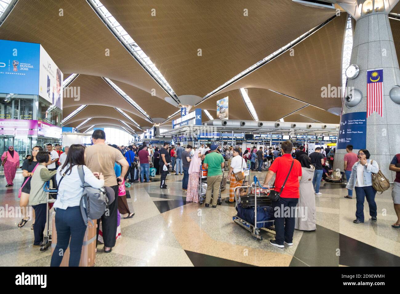 Travelers walking around identifying their flights check-in counters at ...