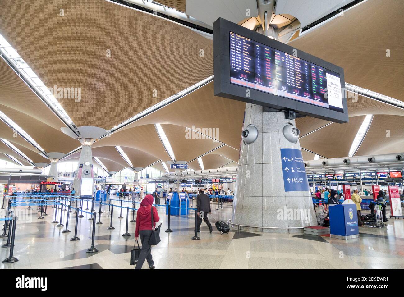 Travelers walking around identifying their flights check-in counters at ...