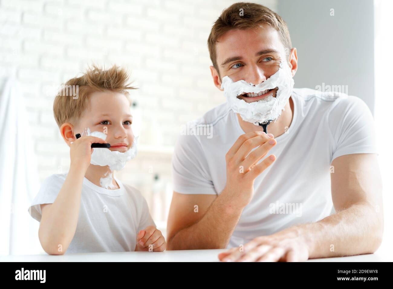 Father teaches his little son how to shave face Stock Photo - Alamy