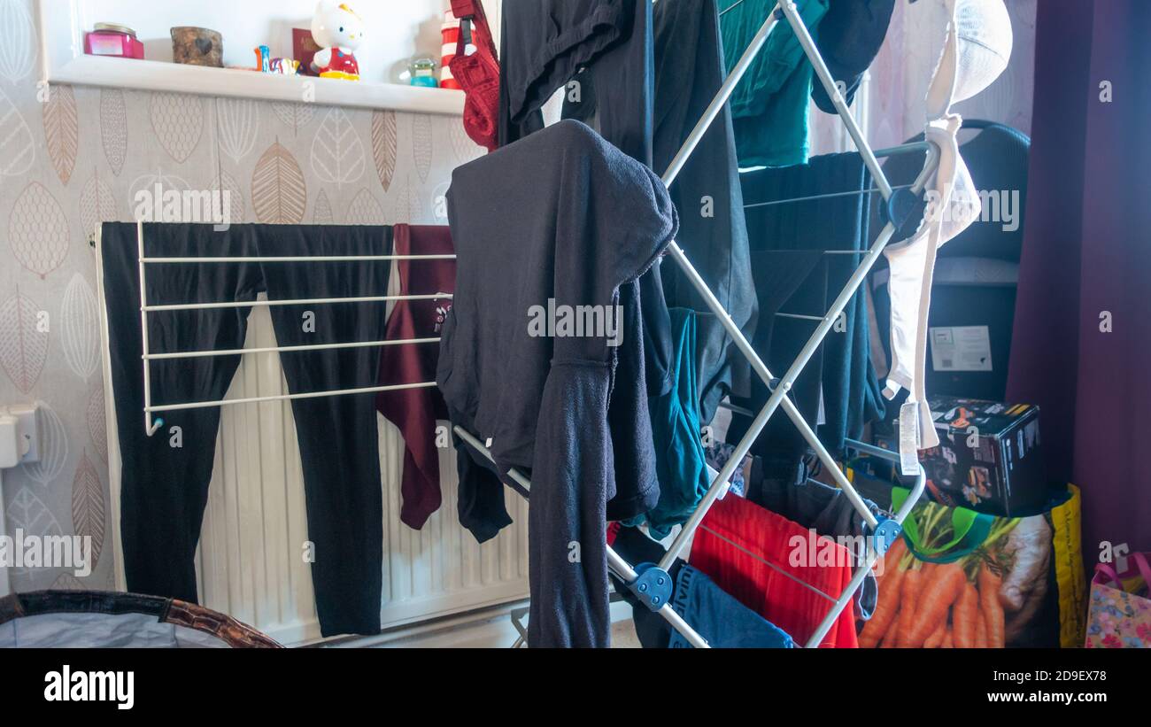 Drying recently washed clothes indoors on a drying rack Stock Photo - Alamy