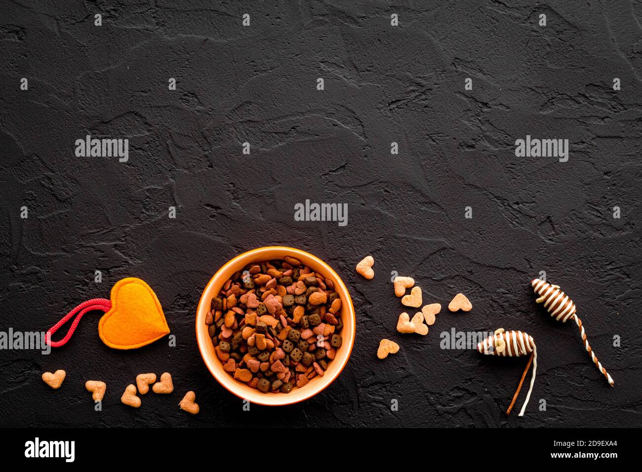 Dry cat food in bowl with toy, top view Stock Photo - Alamy