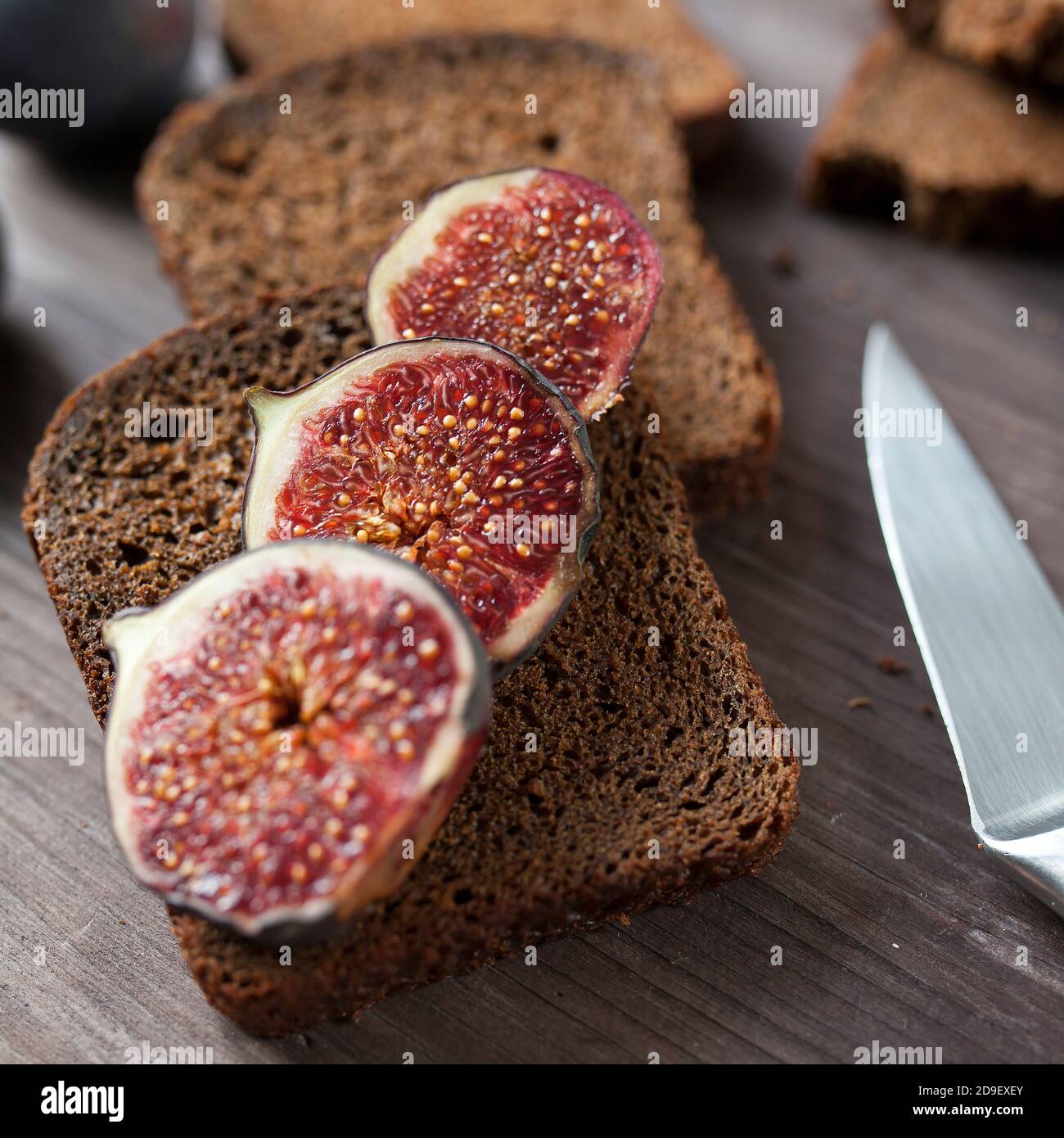 Bunch of fresh ripe figs on wodden brown background. Tropical fruit ...