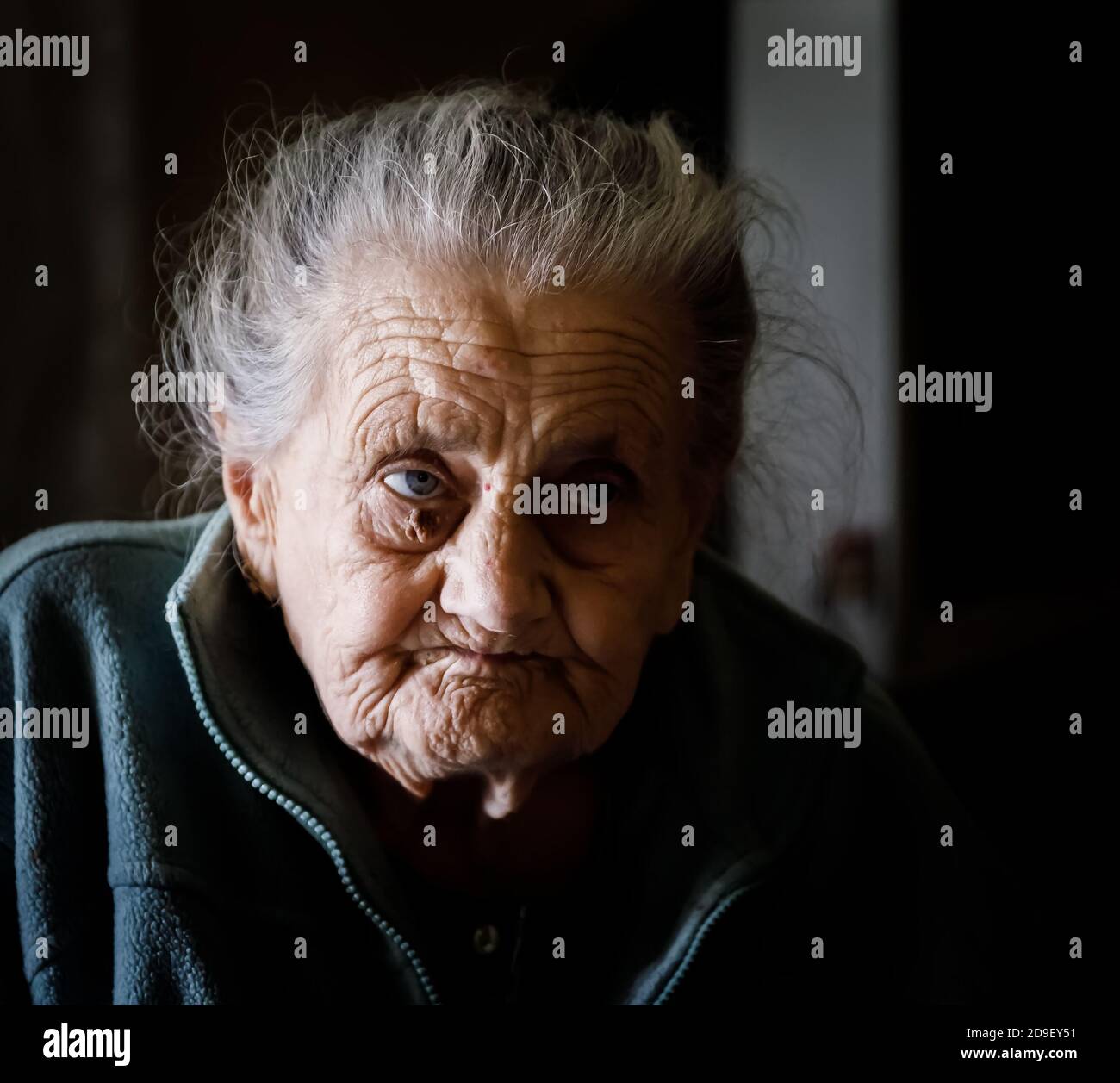 Portrait of a very old tired woman sitting near a window Stock Photo ...
