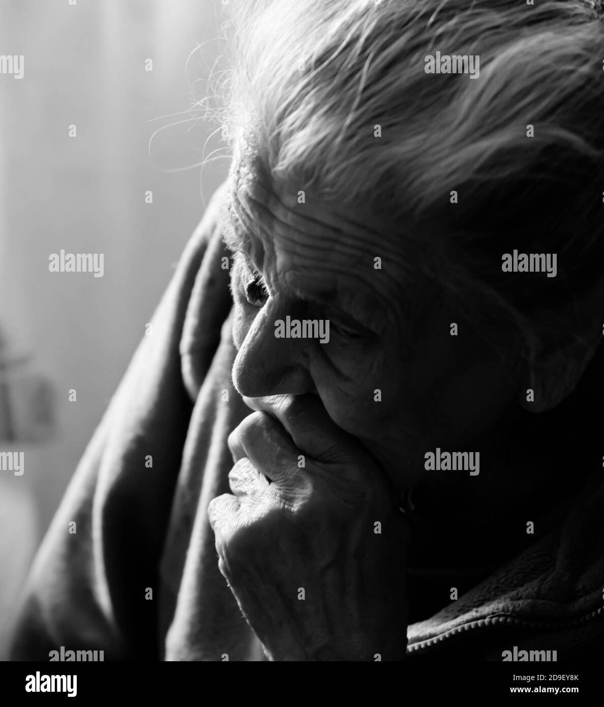 Portrait of a very old tired woman sitting near a window Stock Photo ...